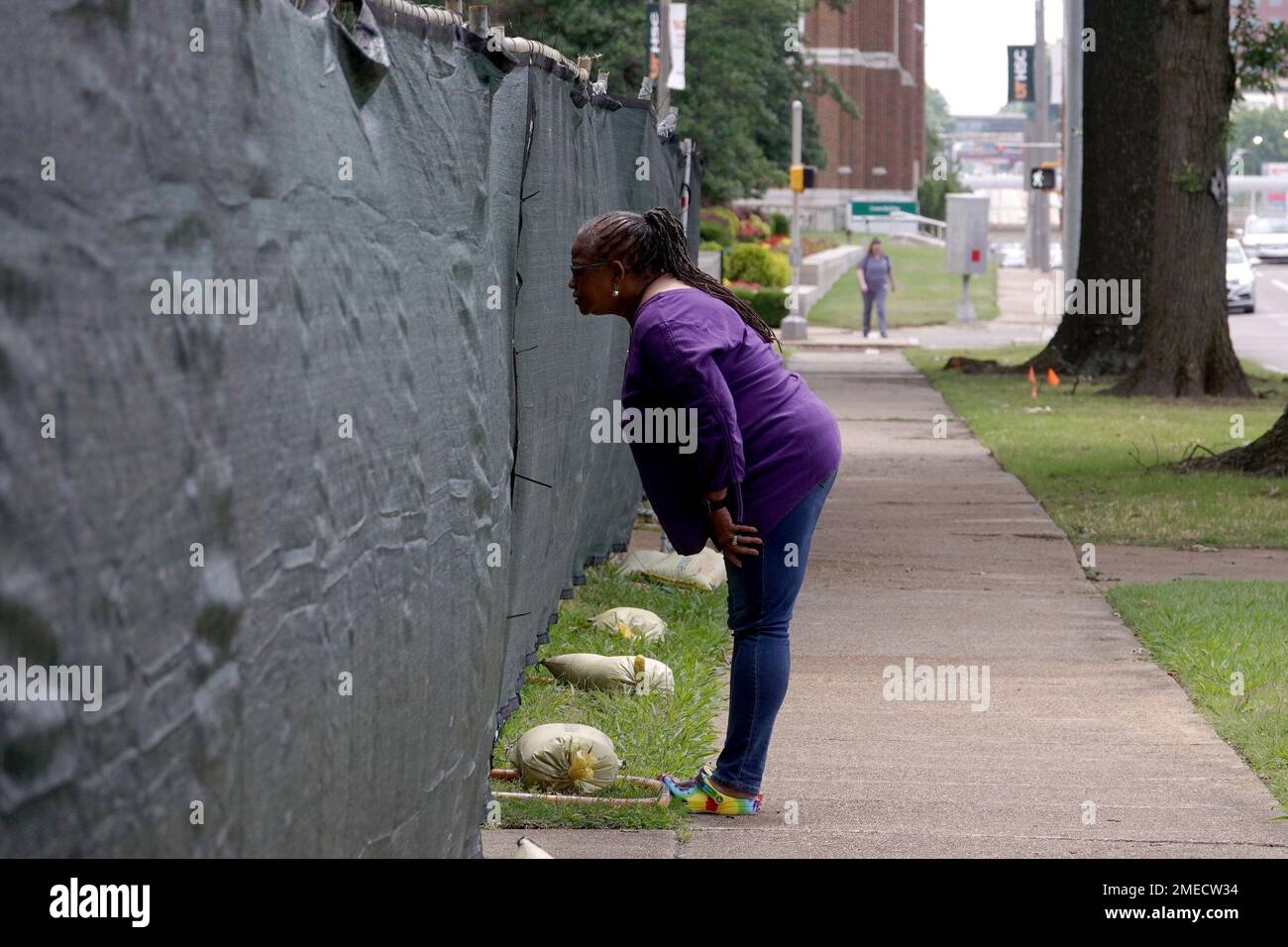 Carolyn Michael-Banks watches as workers dig up the remains of ...