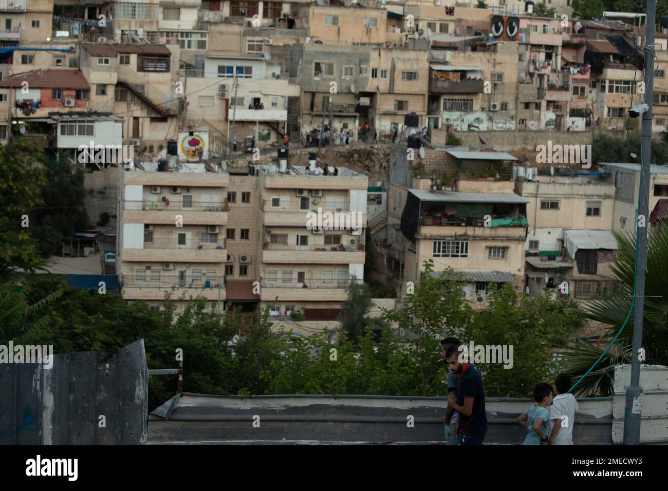 Palestinians watch people running from tear gas fired by Israeli police ...