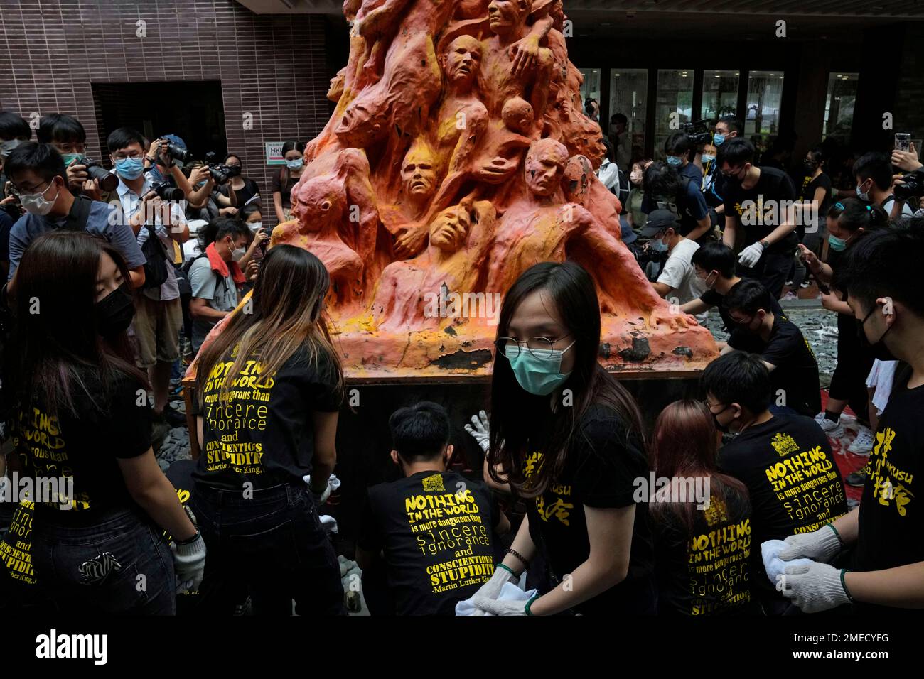 University students clean the "Pillar of Shame" statue, a memorial for ...