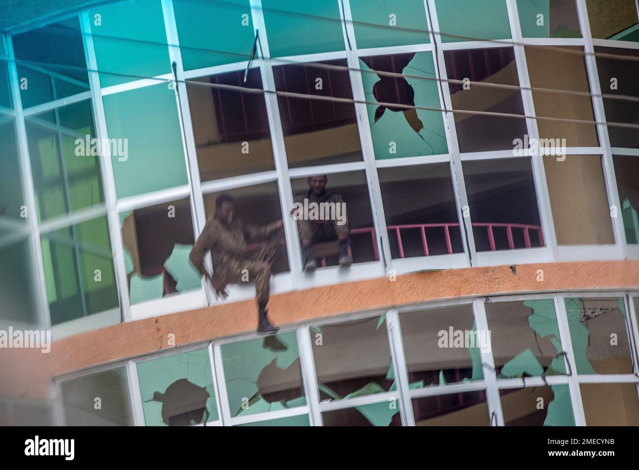 An Ethiopian government soldier climbs out of the broken windows of a ...
