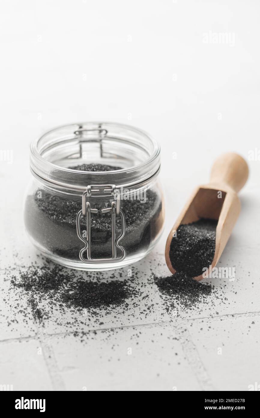 Jar of Hawaiian black lava sea salt . Healthy food concept. Speciality ...