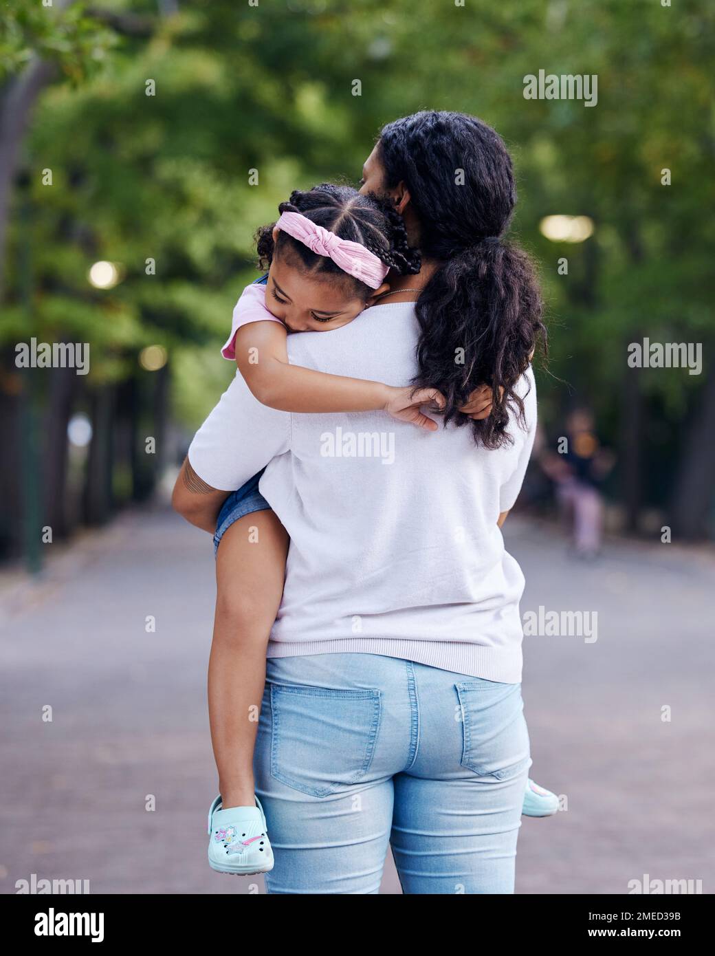 Love, family and mother carrying girl outdoors, bonding and hugging ...