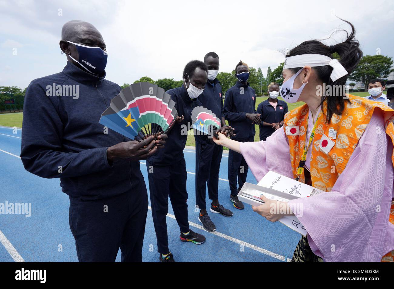 Olympic fan Kyoko Ishikawa, right, give Japanese folding fans depicting ...