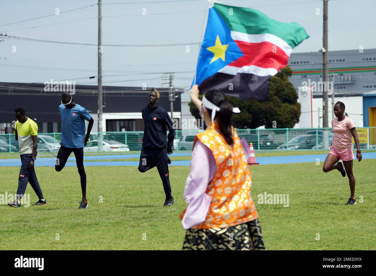Olympic fan Kyoko Ishikawa, front, cheers to the South Sudan team ...