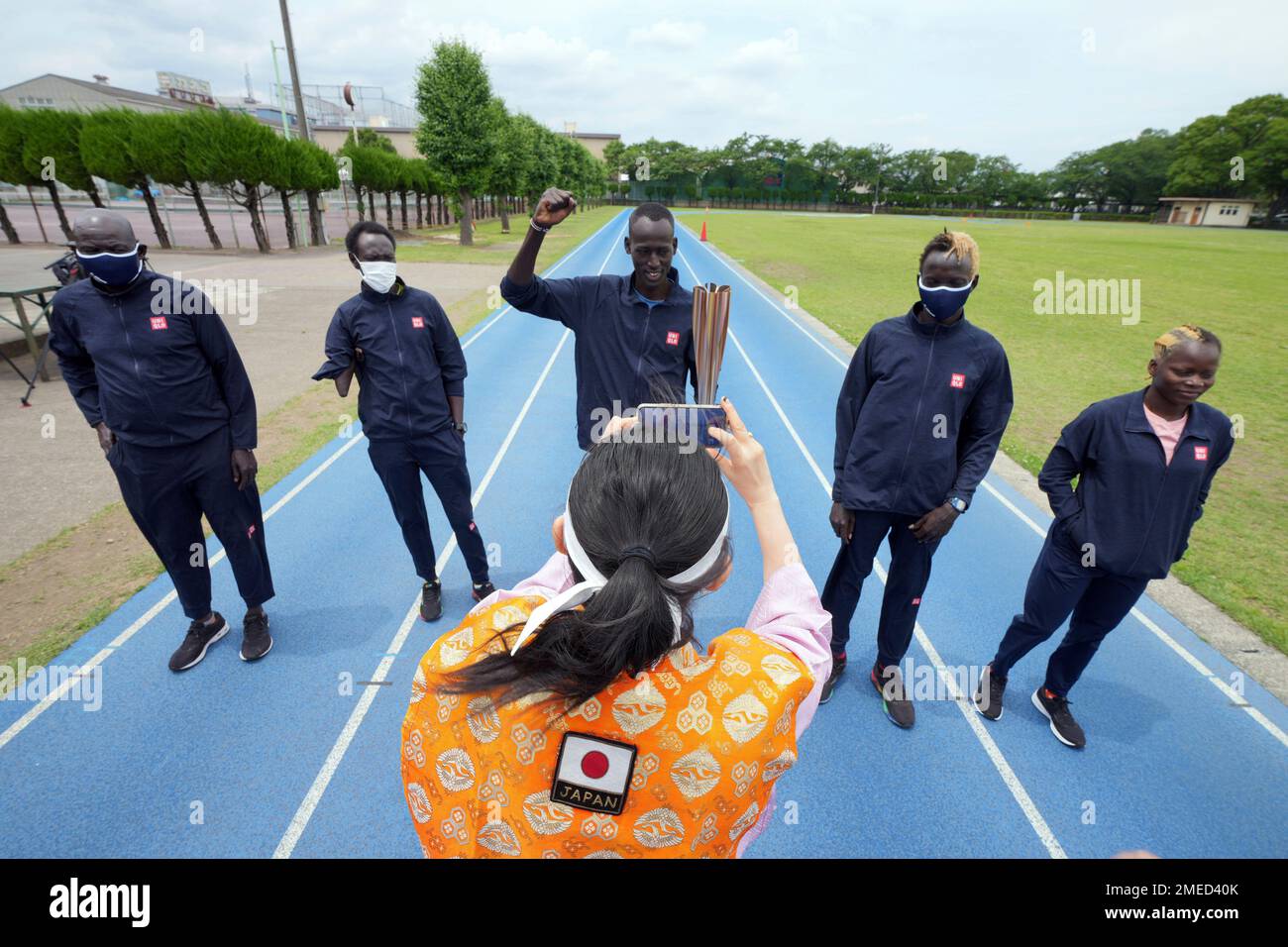 Olympic fan Kyoko Ishikawa takes a photo of the South Sudan athletes ...