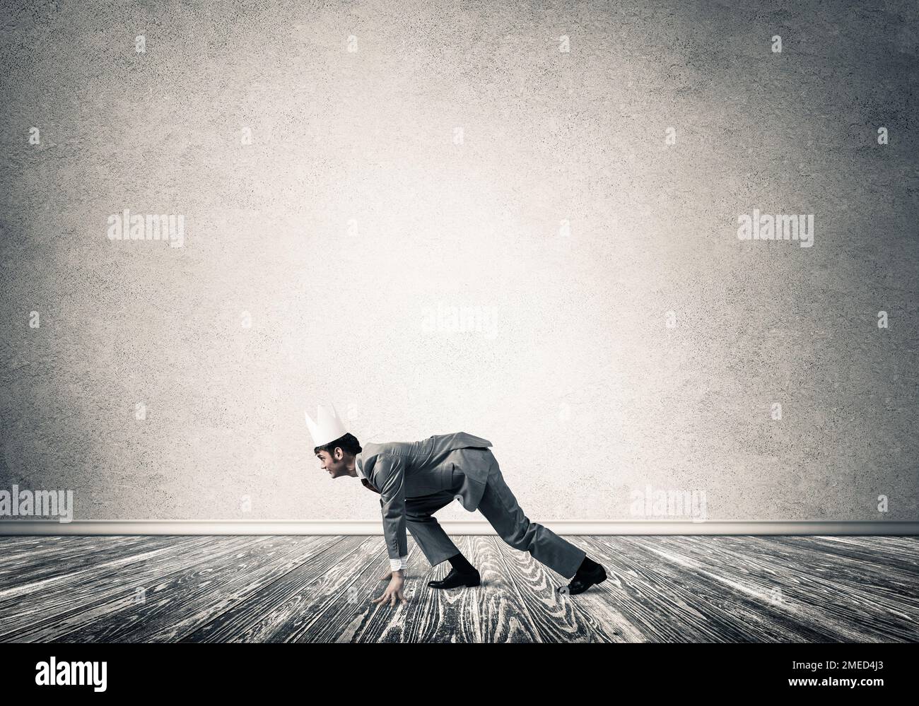 King businessman in elegant suit running in empty room Stock Photo - Alamy
