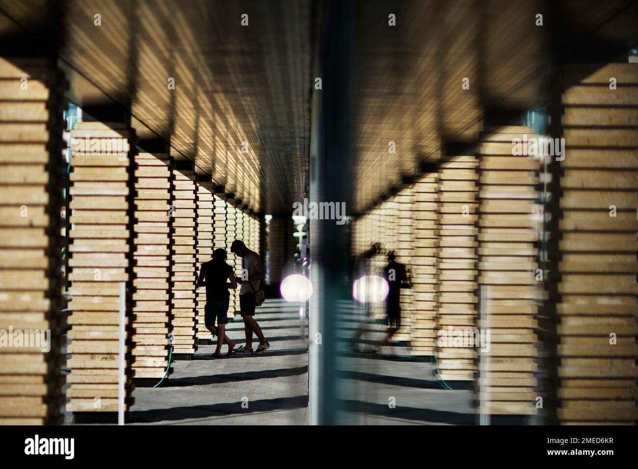 Shoppers rest in the shade along an outdoor mall in Herzliya, Israel ...