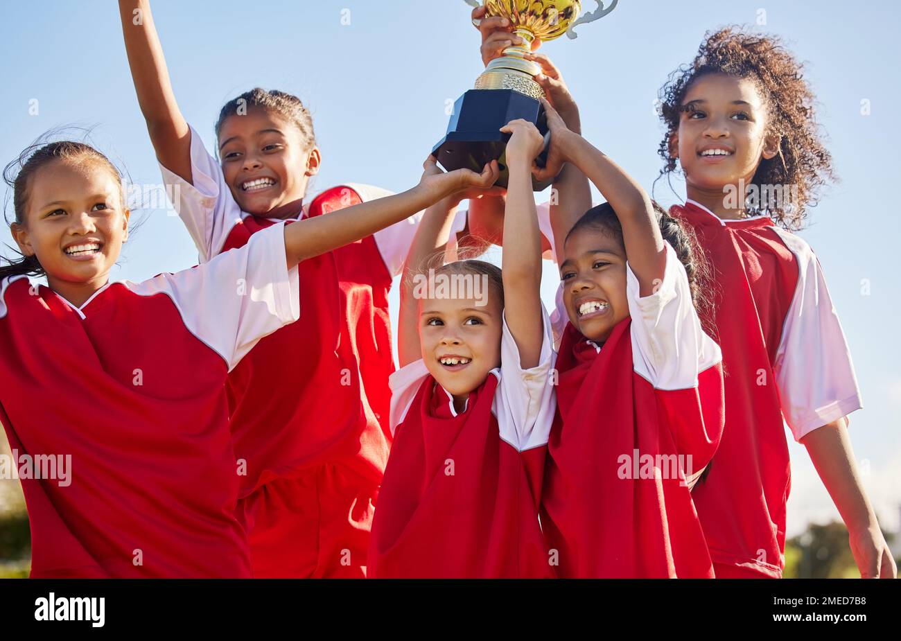 Soccer, team and trophy with kids in celebration together as a girl winner group for a sports ...