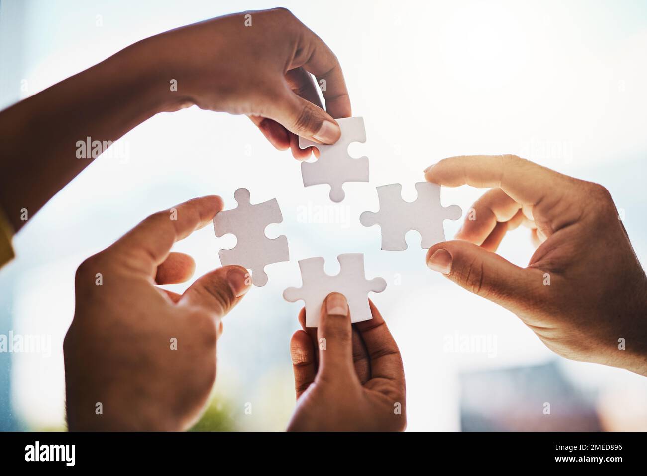 Teamwork makes a puzzle whole. businesspeople completing a puzzle ...