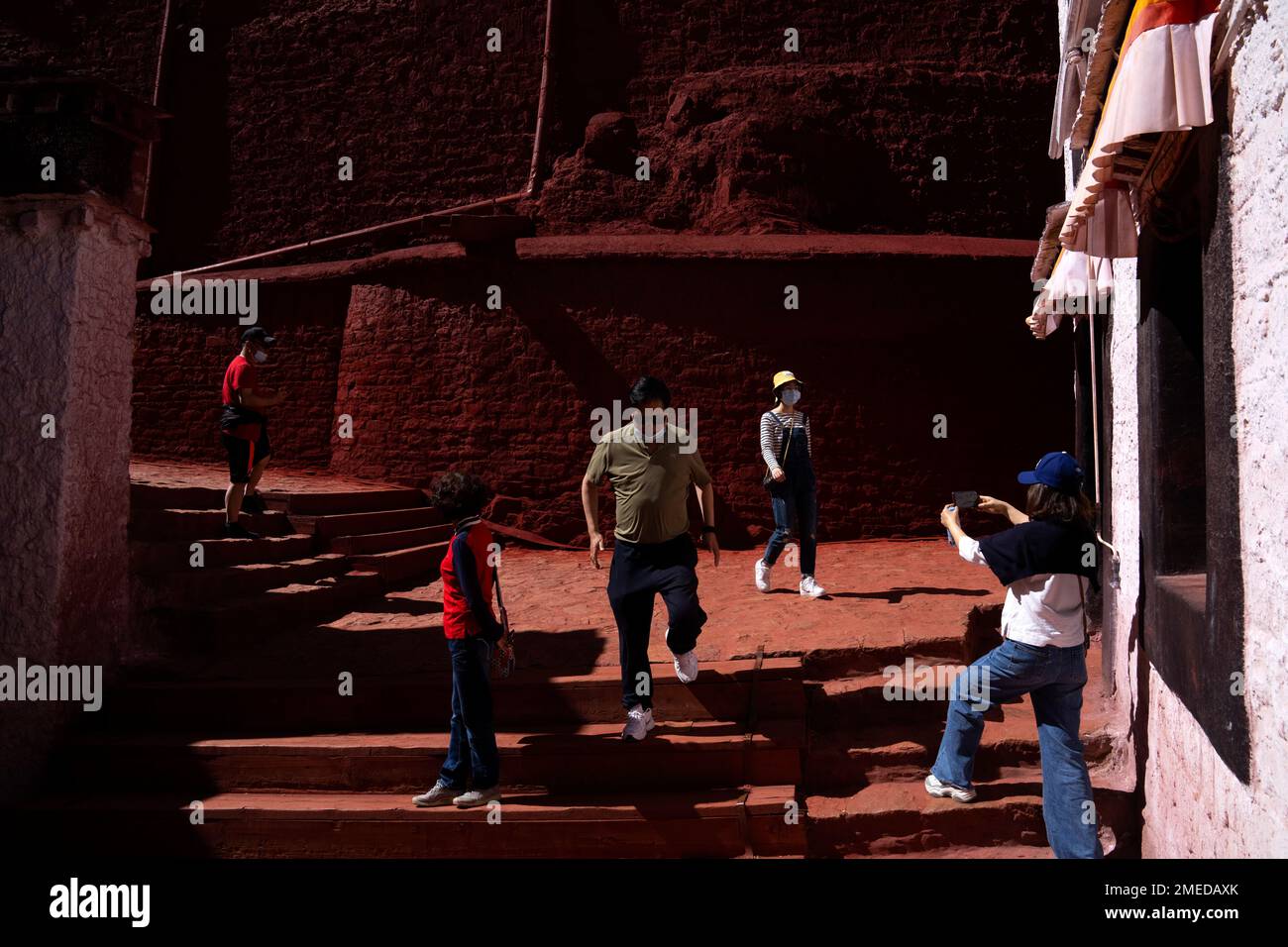 Tourists walk inside the grounds of the Potala Palace in Lhasa in ...
