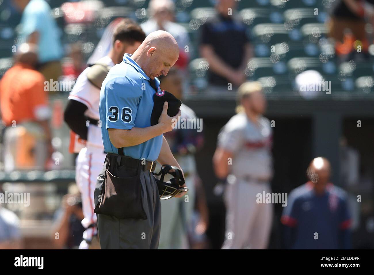 Home plate umpire Ryan Blakney pauses for a moment of silence in honor ...