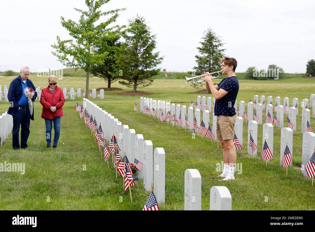 Miles Hagen, 19, part of Bugles Across America, plays the trumpet as ...