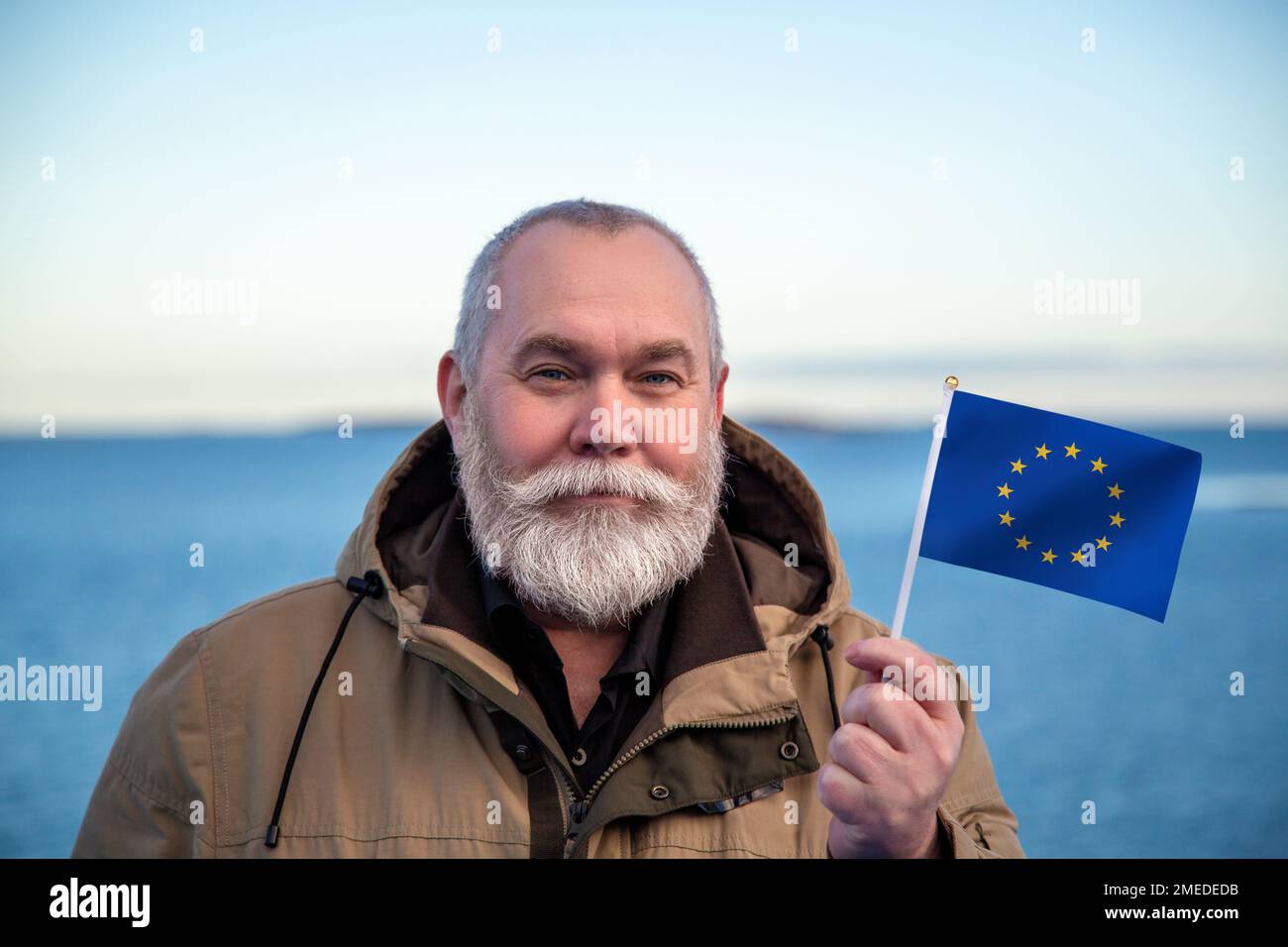 Man holding European flag. Portrait of older man with the EU flag ...