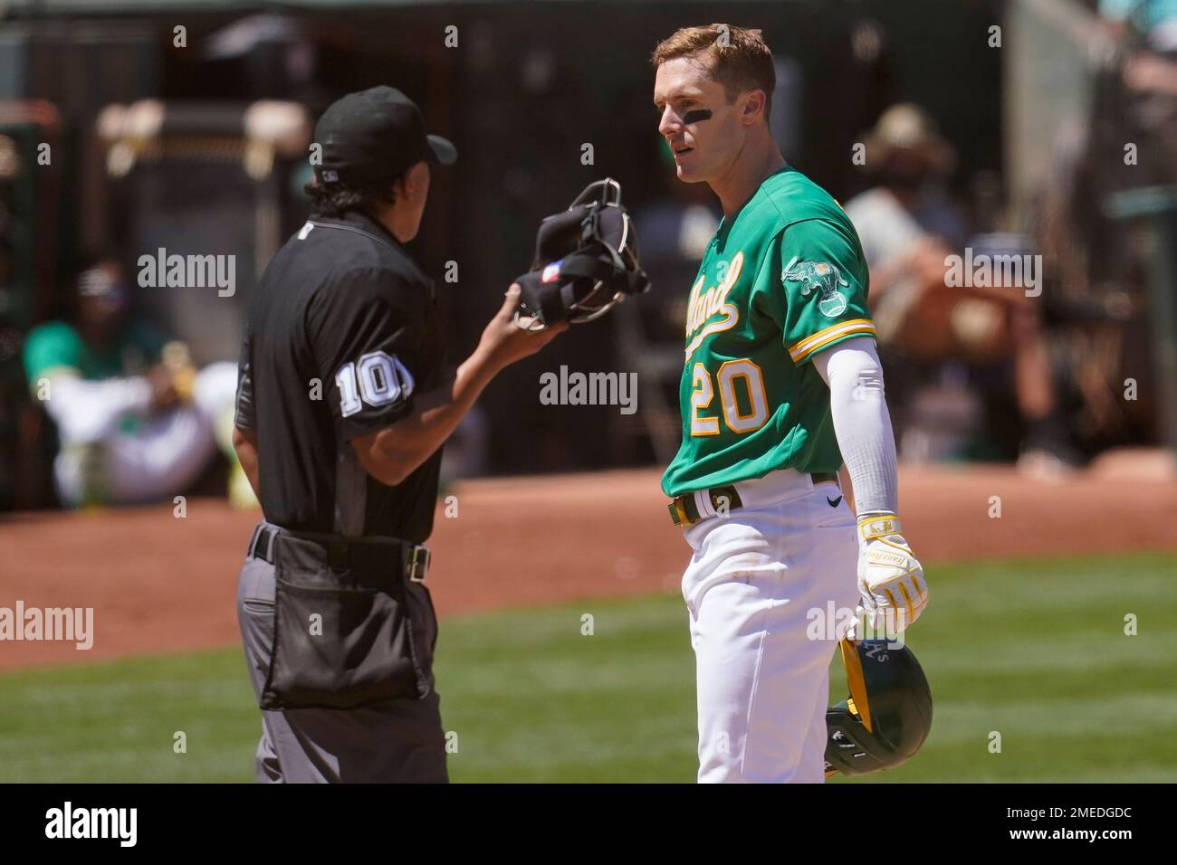 Oakland Athletics' Mark Canha, right, reacts toward home plate umpire ...