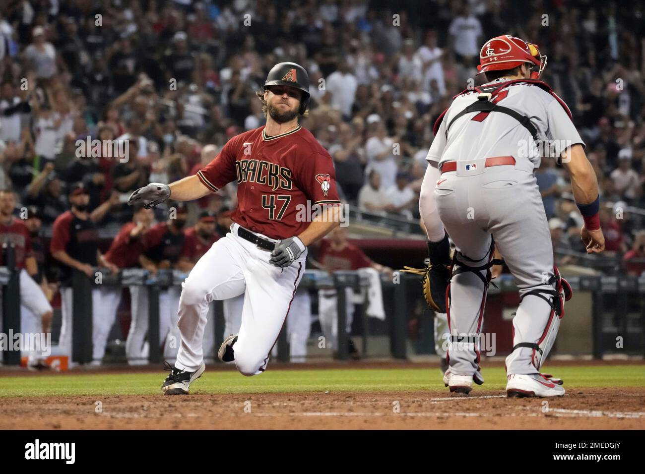 Arizona Diamondbacks' Matt Peacock (47) scores a run in the fourth ...