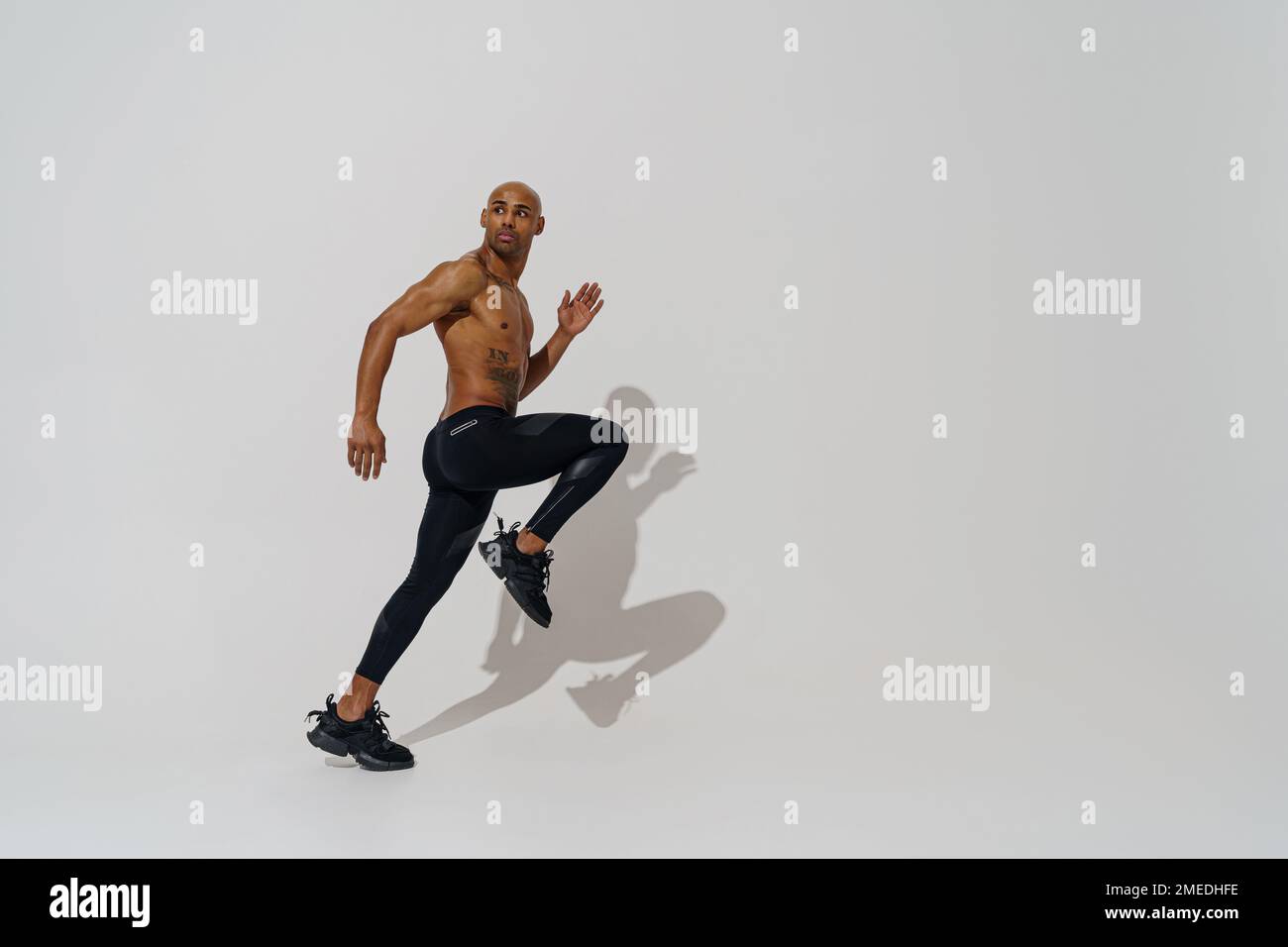 Professional male athlete running isolated on white studio background ...