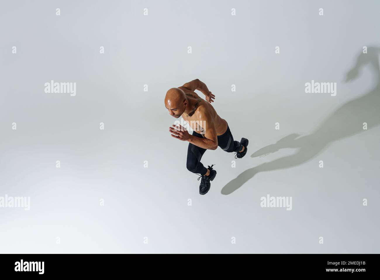 Top view of Professional male athlete running isolated on white studio ...