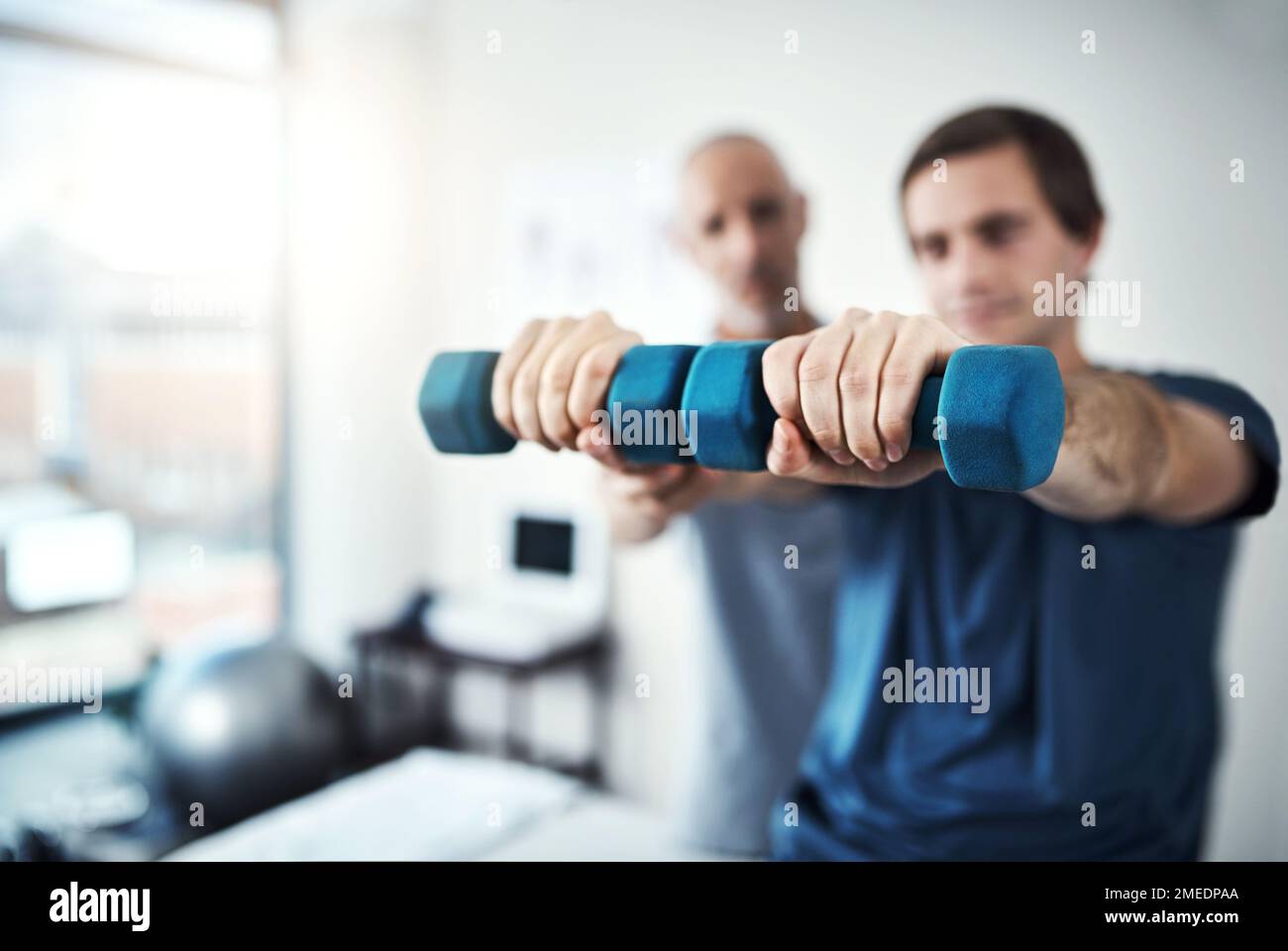 Got to keep your strength up. a physiotherapist helping a patient work ...