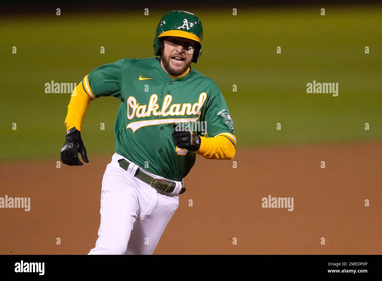 Oakland Athletics' Jed Lowrie rounds third base to score on a single by ...