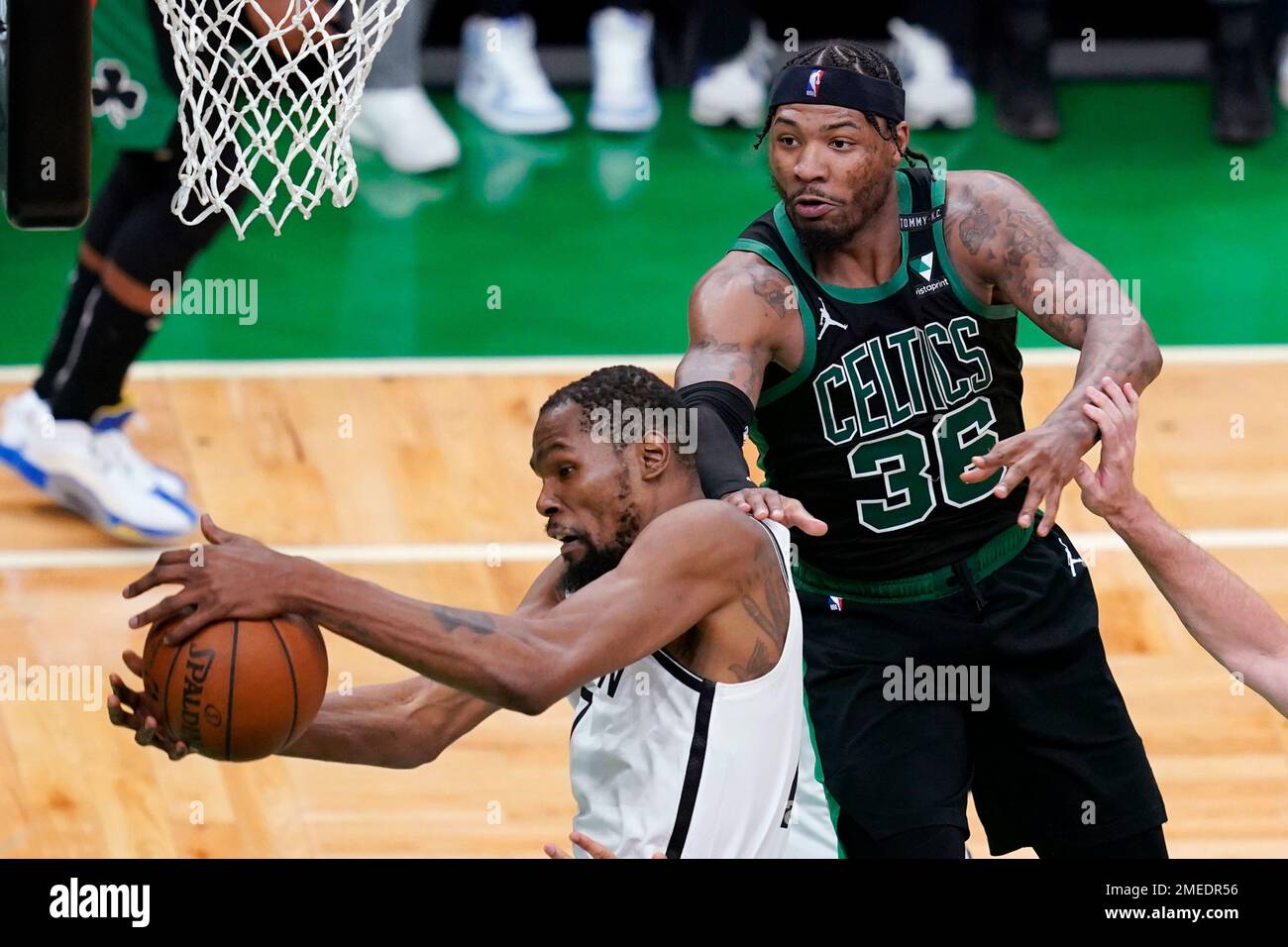 Brooklyn Nets forward Kevin Durant grabs a rebound in front of Boston ...