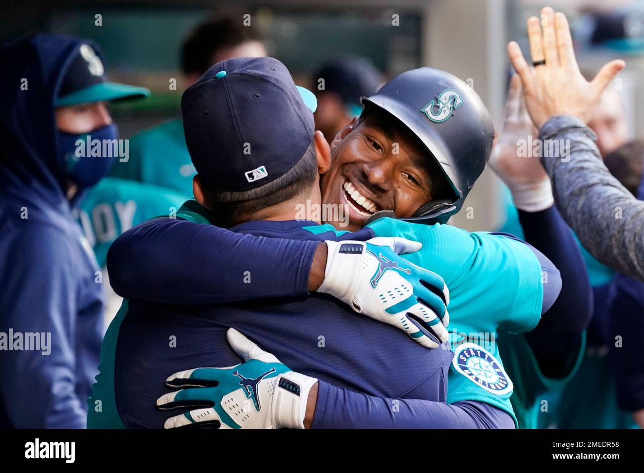 Seattle Mariners' Kyle Lewis is embraced by a teammate after his two ...