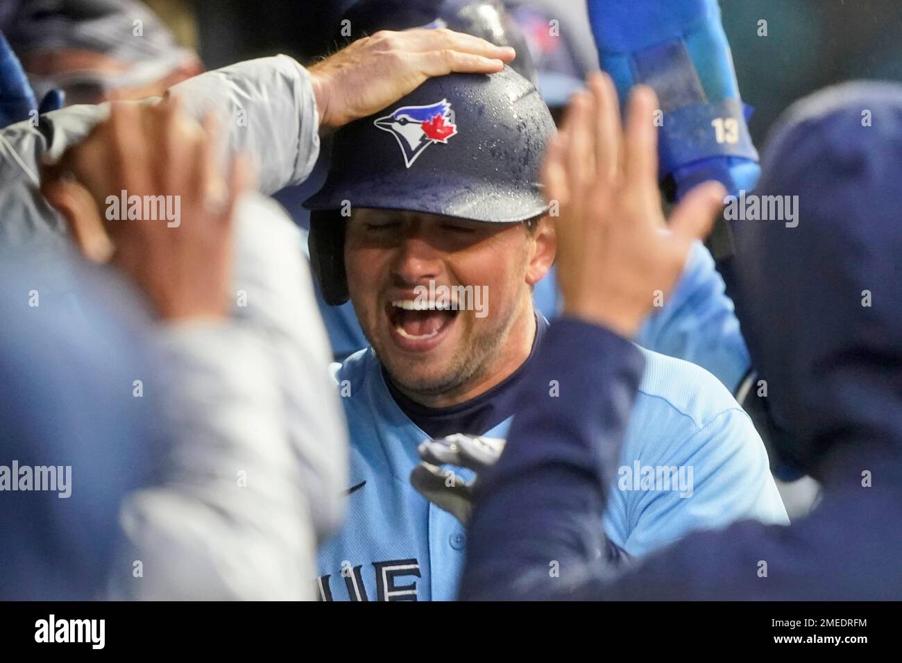 Toronto Blue Jays' Joe Panik is congratulated by teammates after ...