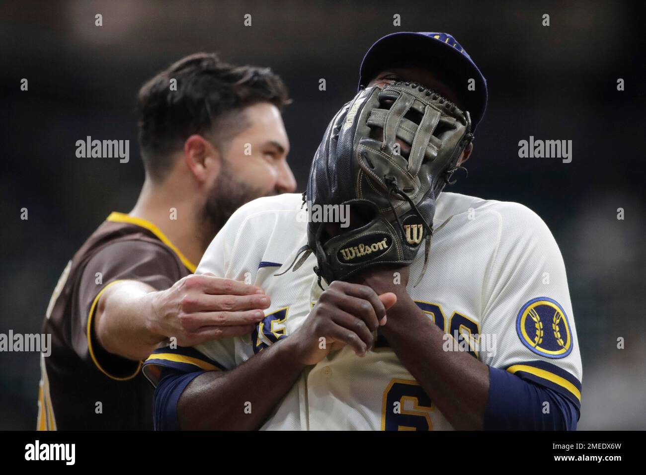 Milwaukee Brewers' Lorenzo Cain laughs with San Diego Padres' Eric ...