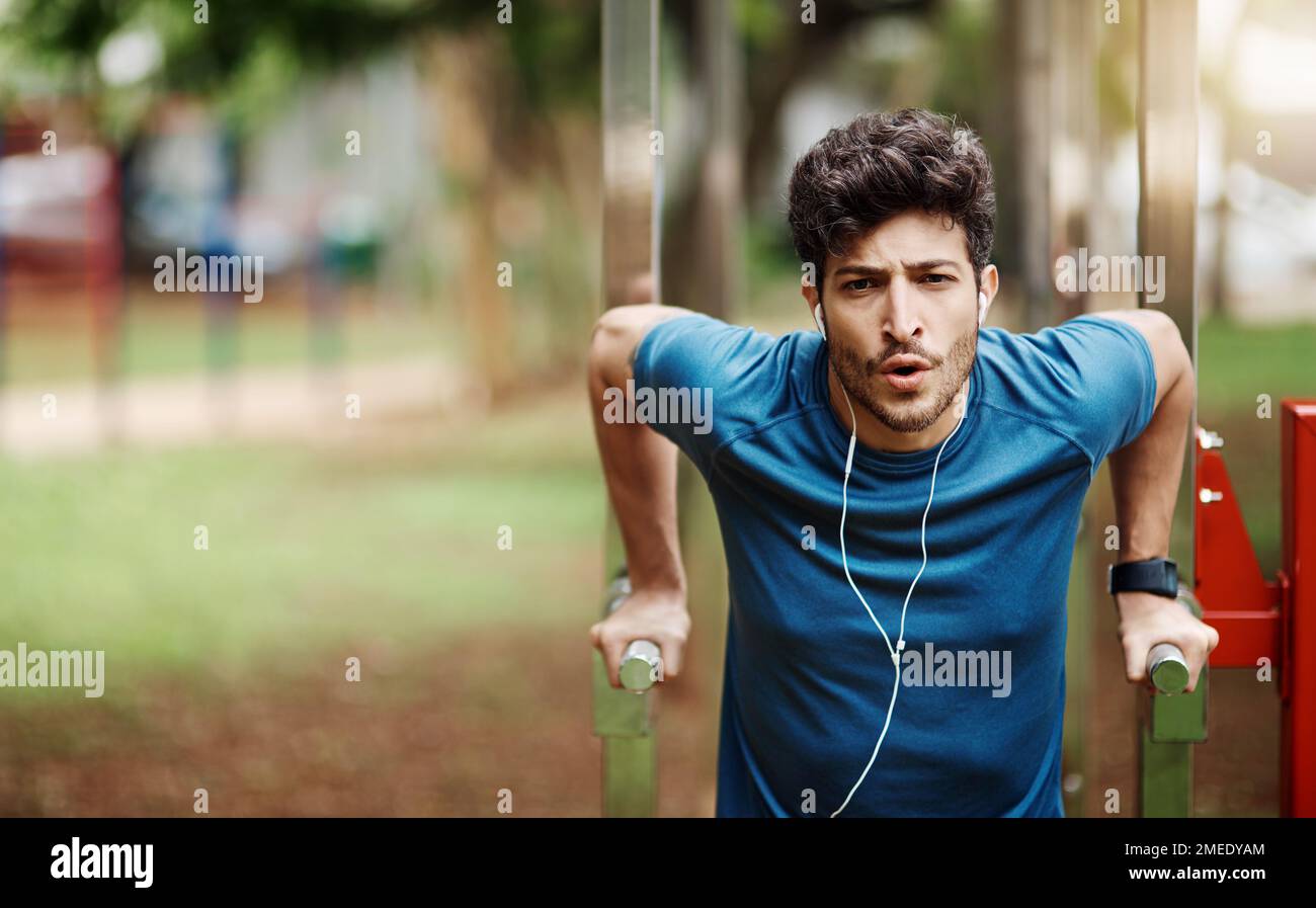 Doing a different exercise for a change. Portrait of a sporty young man ...