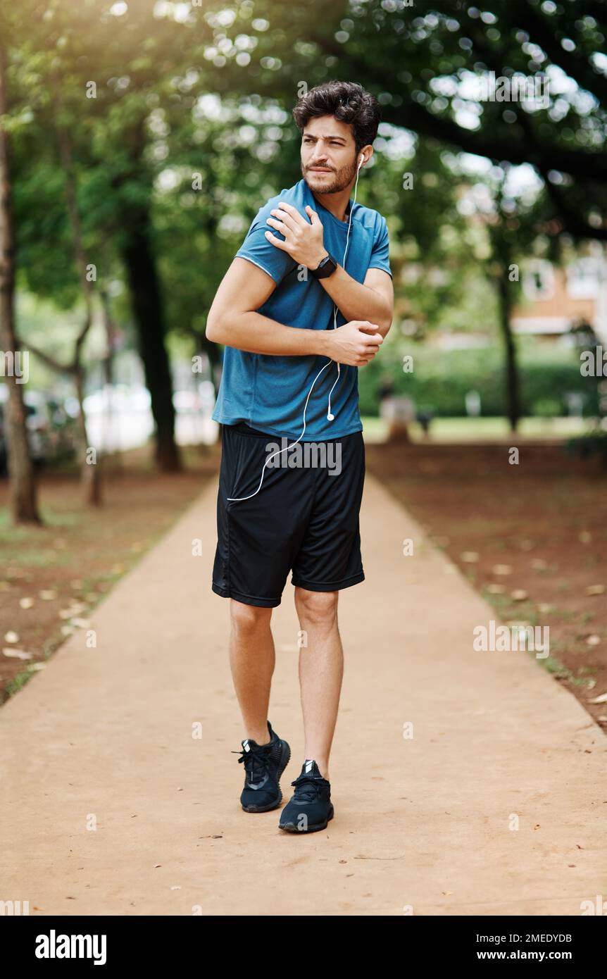 Yeah my run id looking a bit awkward. a sporty young man holding his ...