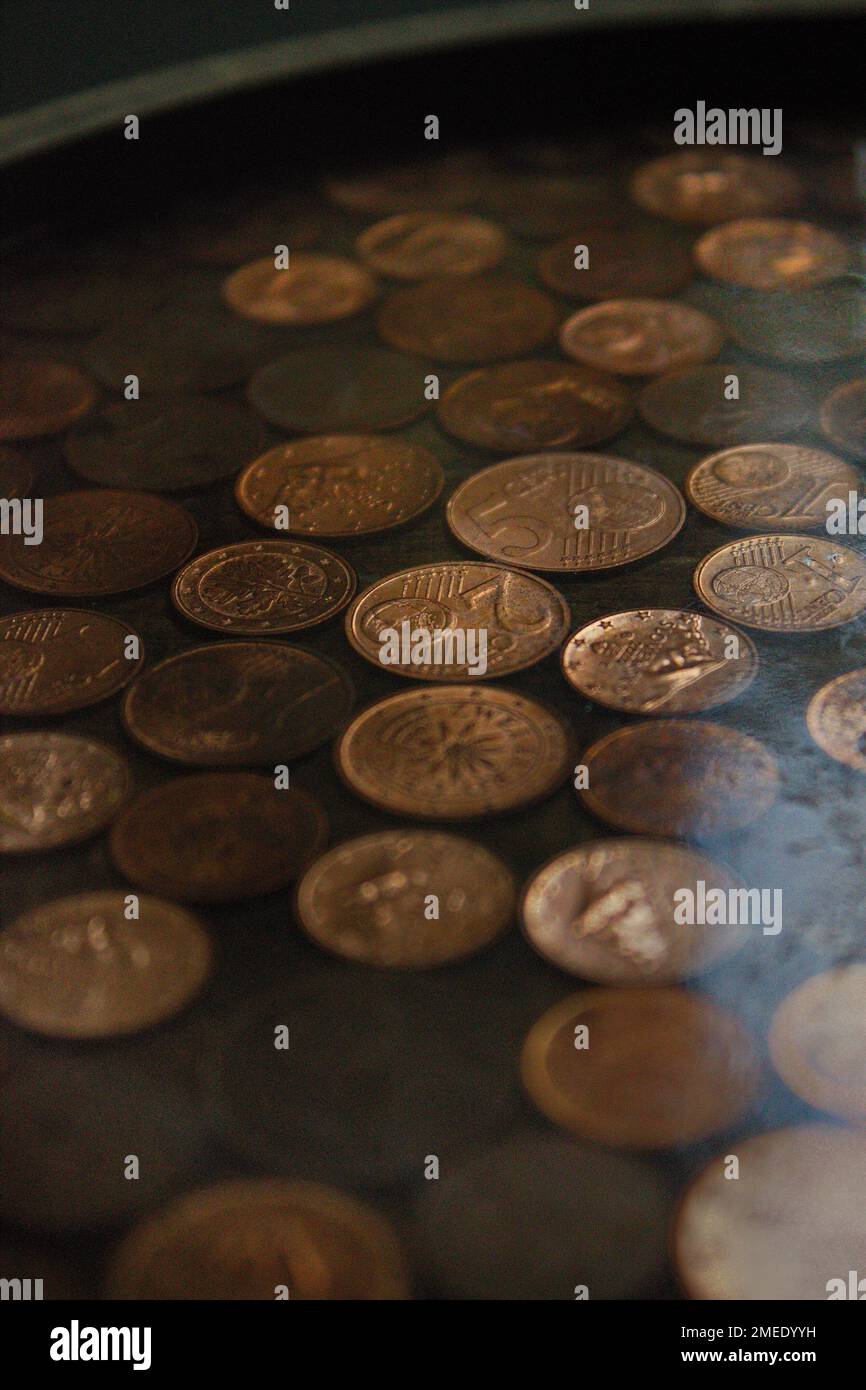 A vertical closeup of euro coins on display covered with glass Stock ...