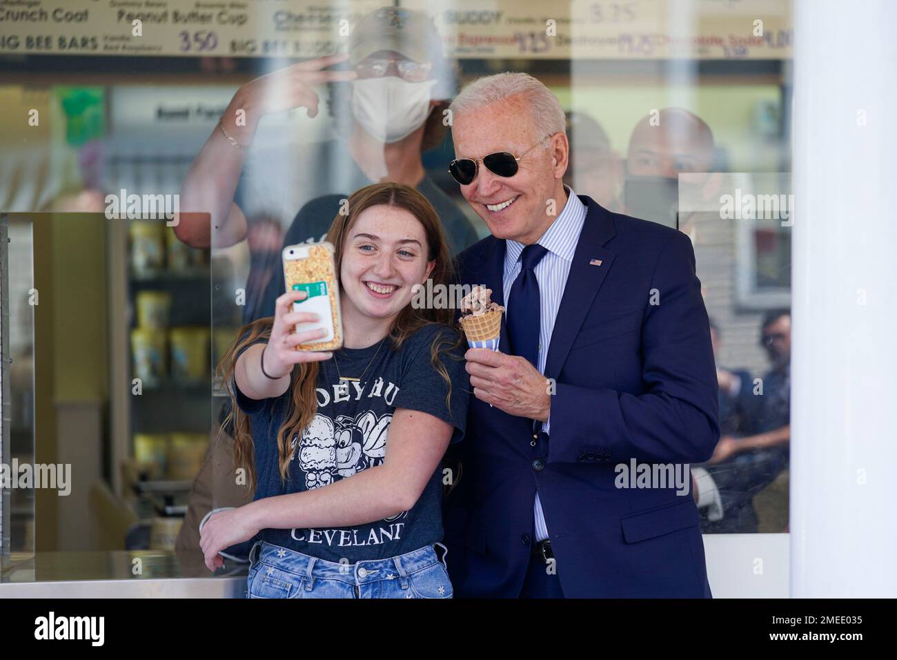 President Joe Biden poses for a photo with an employee at Honey Hut Ice ...