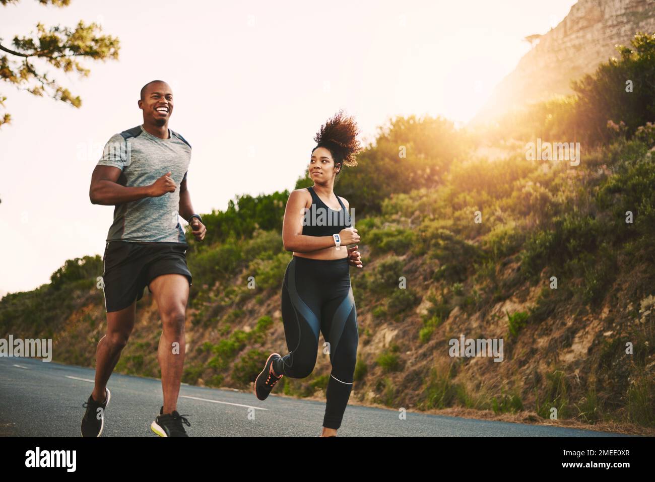 I look to him for inspiration. a young couple out running together ...