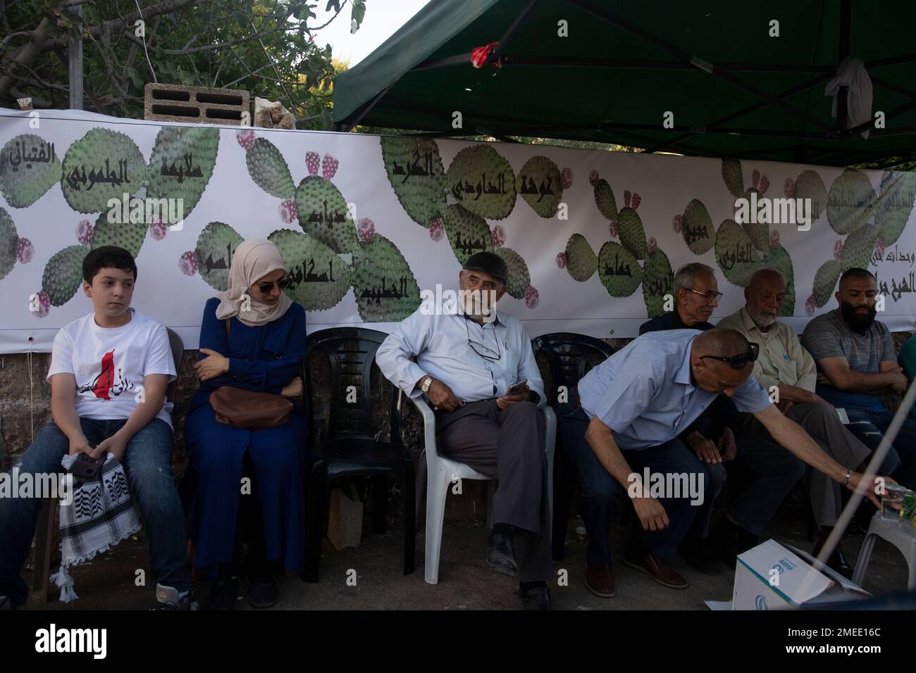 Nabil el-Kurd, center, whose family home is partially occupied by an ...