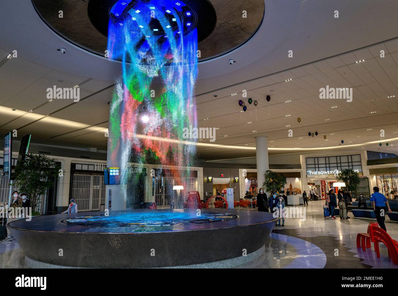 One of two colorful 25-foot-tall indoor fountains greets passengers ...