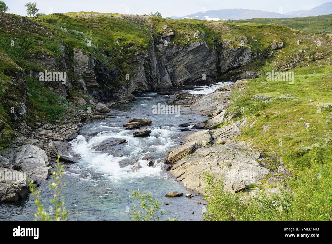 River in Swedish mountain area with some rapids and flowing in smaller ...