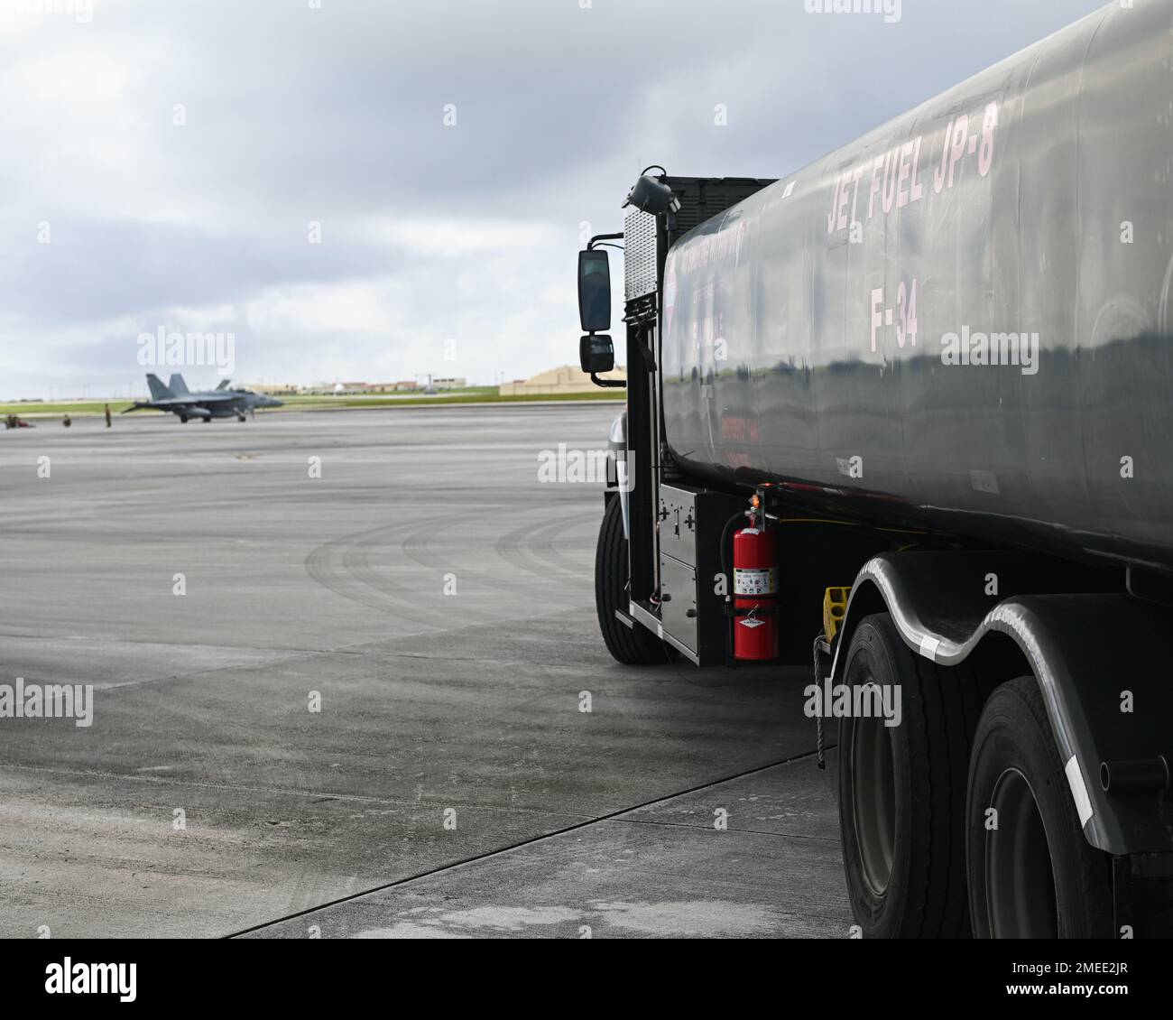 An R-11 Refueler is on stand-by to refuel a U.S. Marine Corps F/A-18 ...
