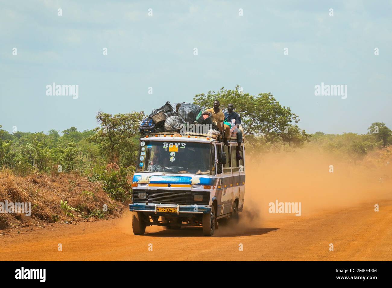 Crowded African Public Bus with the Bags on the Dusty Road in the heart ...