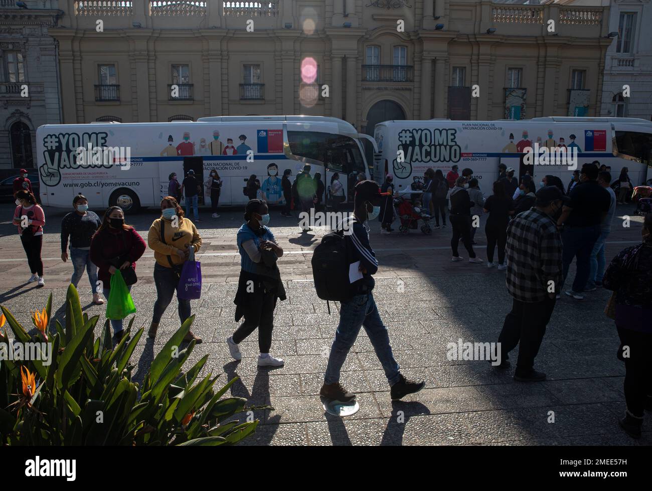 People in line up outside buses being used as COVID-19 vaccination ...