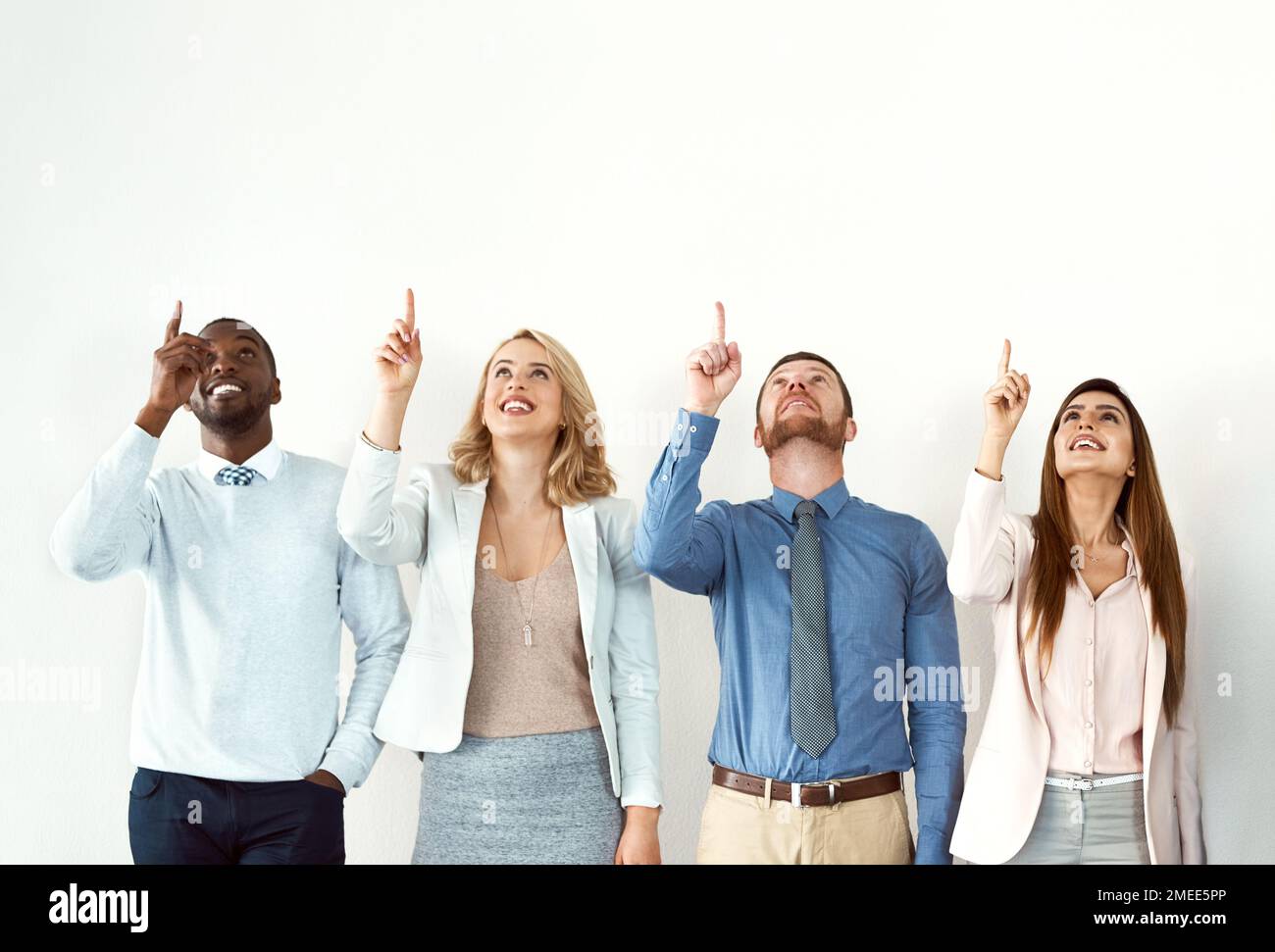 Look to the sky. a group of work colleagues looking up and pointing ...