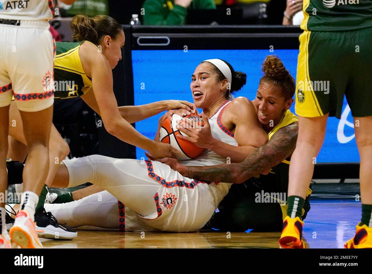 Connecticut Sun's Brionna Jones, center, tries to keep the ball from ...