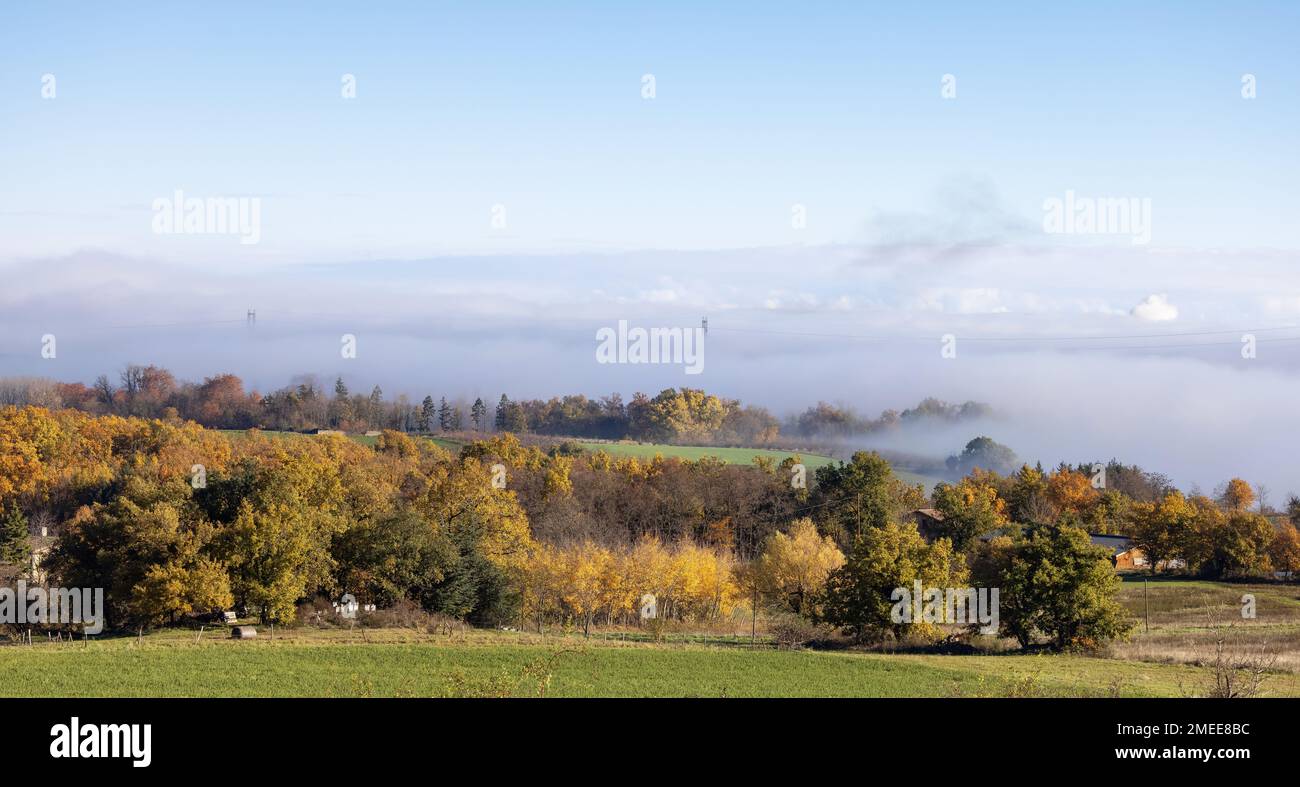 Farm Lands on top of a hill overlooking landscape covered in clouds ...