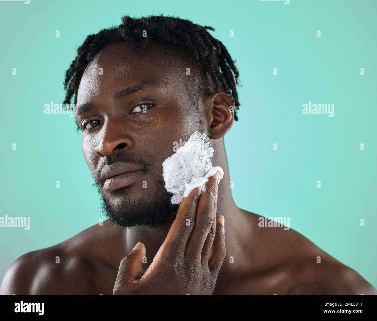 Black man, apply foam and studio portrait for shaving, skincare or safety for cosmetics by blue ...