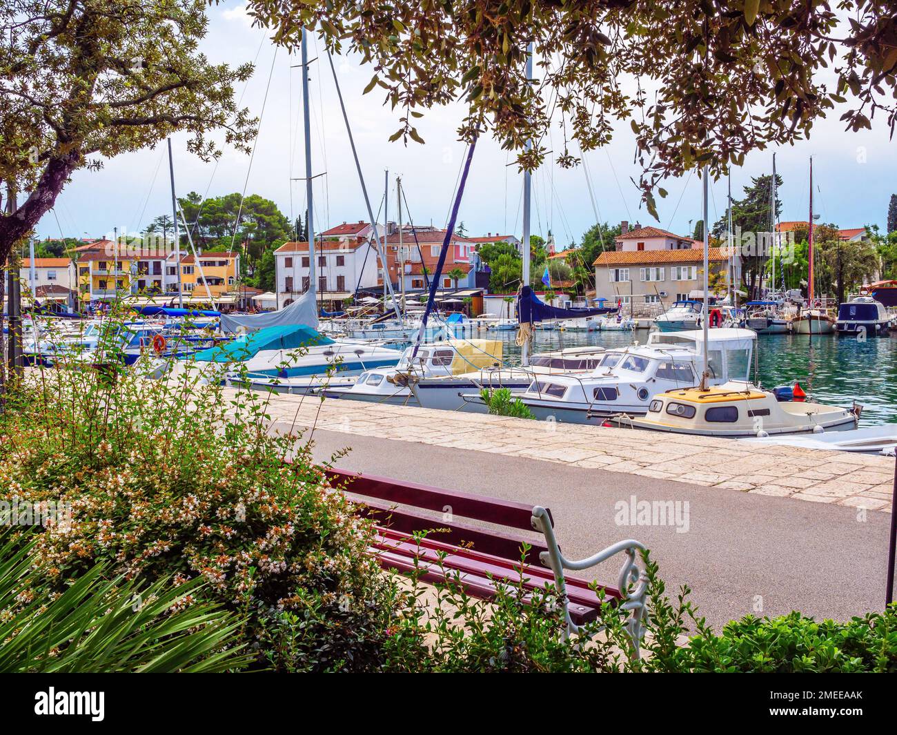 A scenic view of small boats docked at a harbor seen on a sunny day ...