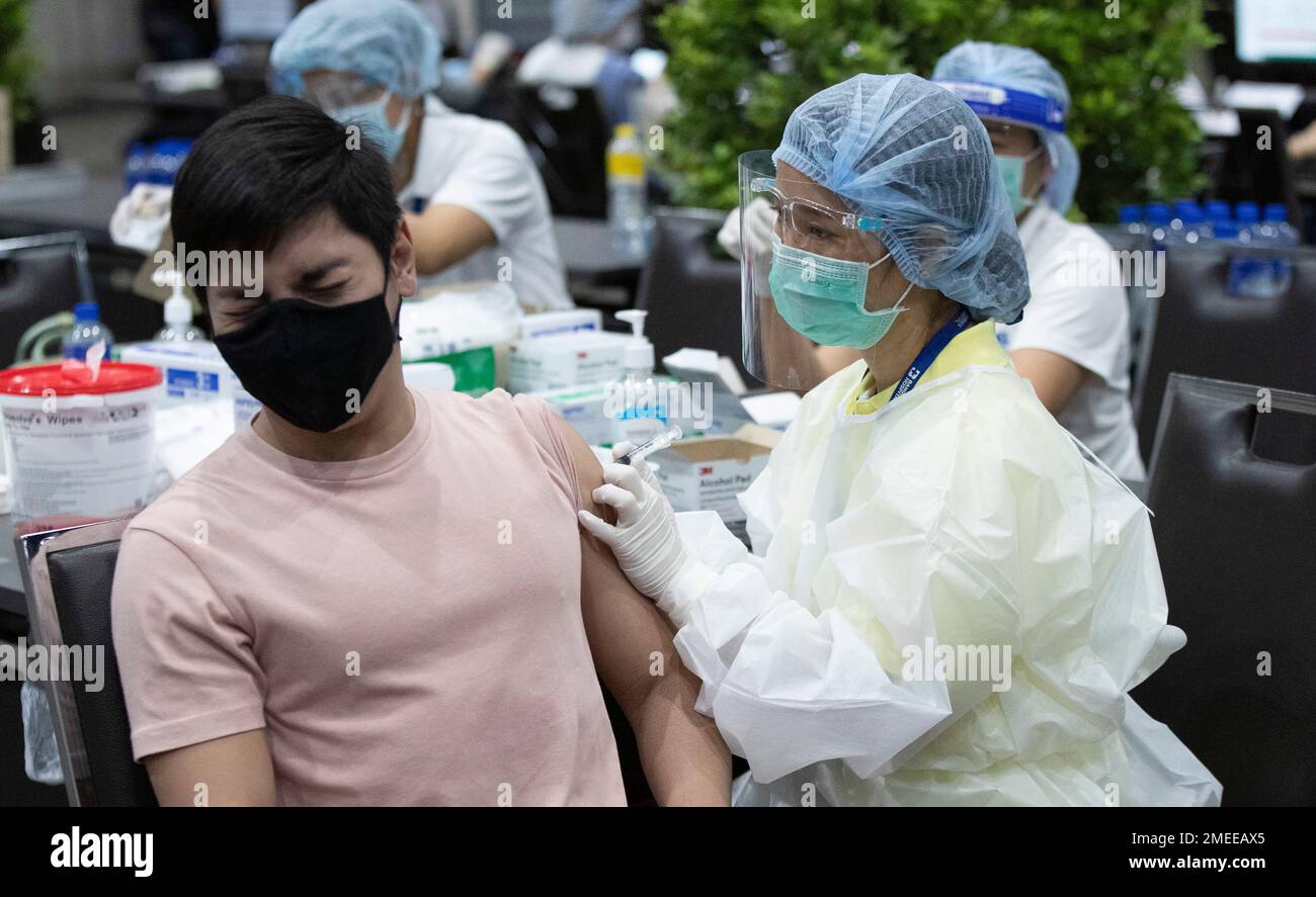 A health worker administers a dose of the Sinovac COVID-19 vaccine for airline employees at the ...
