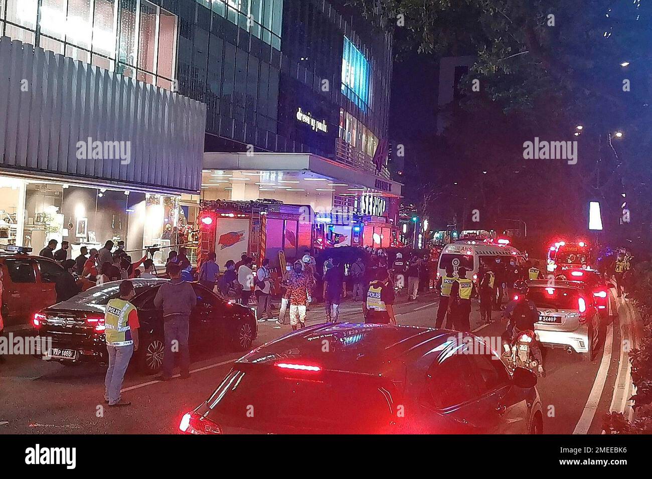 Fire and rescue personnel gather outside a shopping mall to help ...