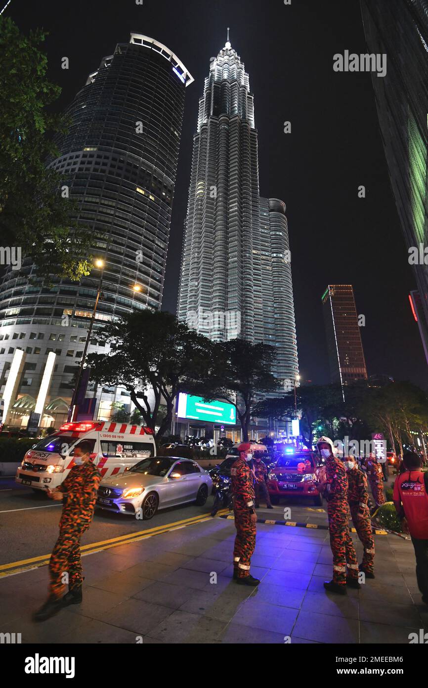 Fire and rescue personnel gather outside a shopping mall to help ...