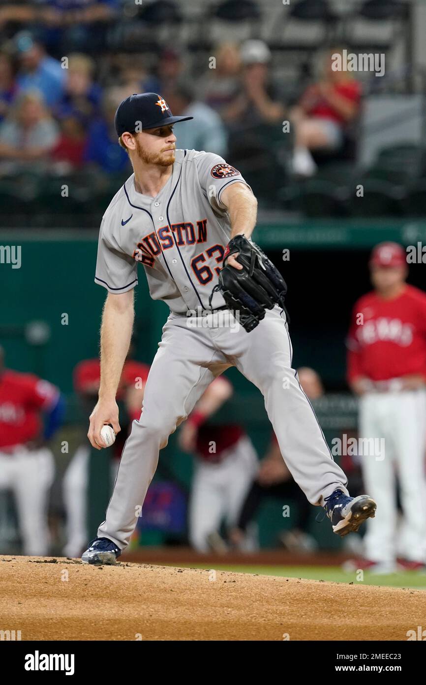 Houston Astros starting pitcher Tyler Ivey winds up to deliver to the ...