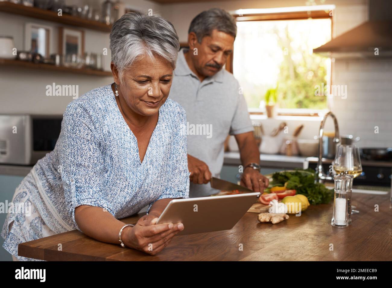 Couple cooking together using a recipe hi-res stock photography and ...
