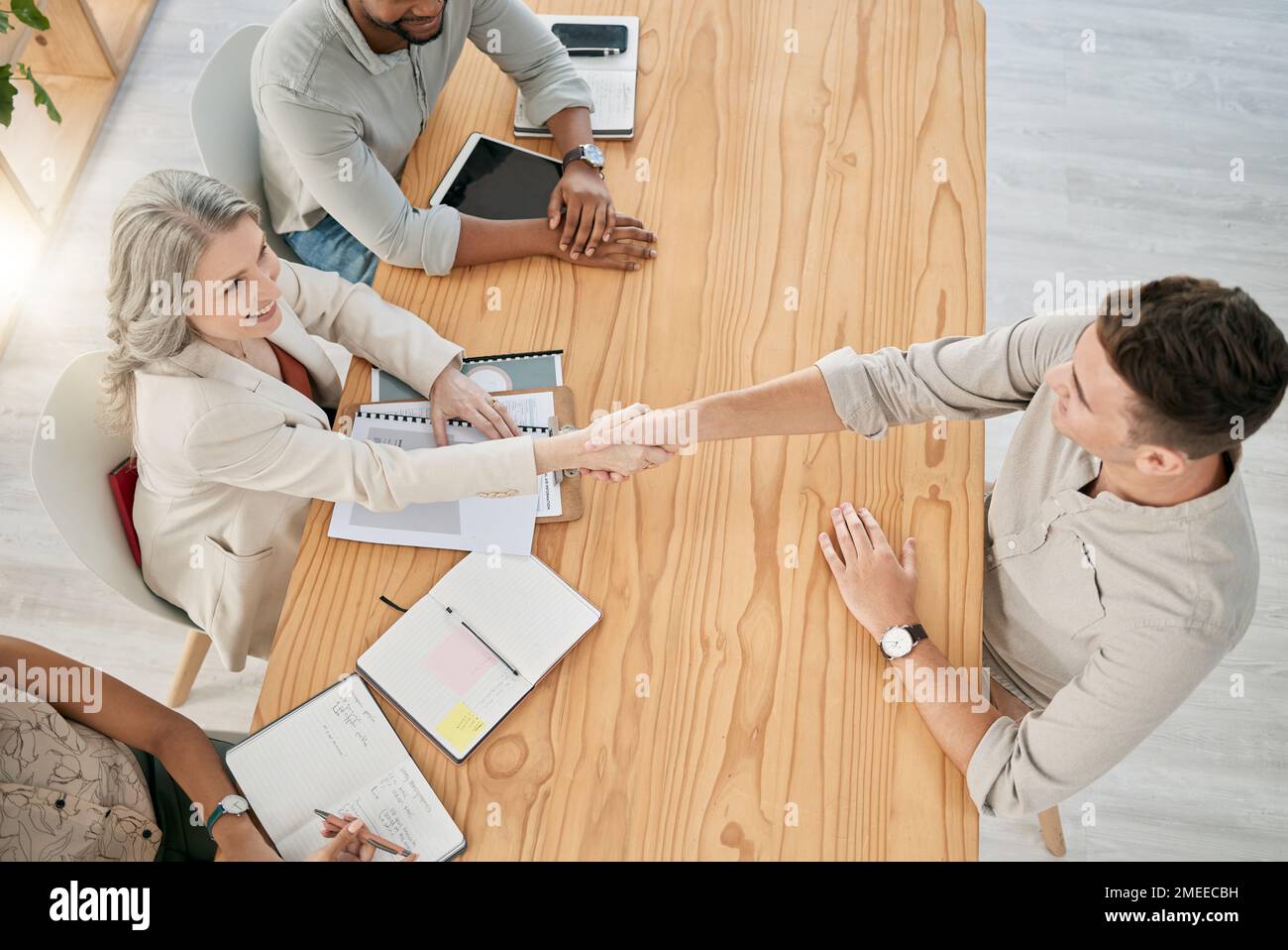 Top view, meeting and handshake of business people in office. Welcome ...