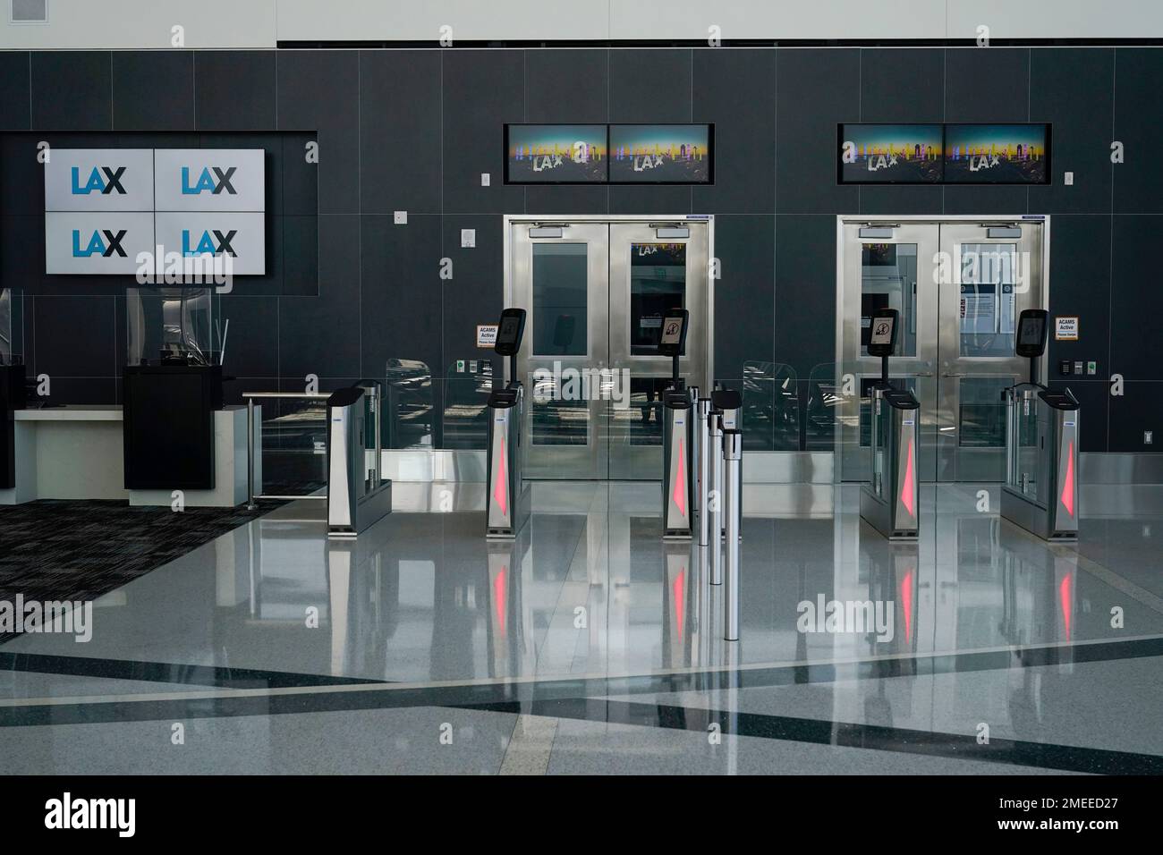A biometric boarding gate allows passengers to check boarding passes ...